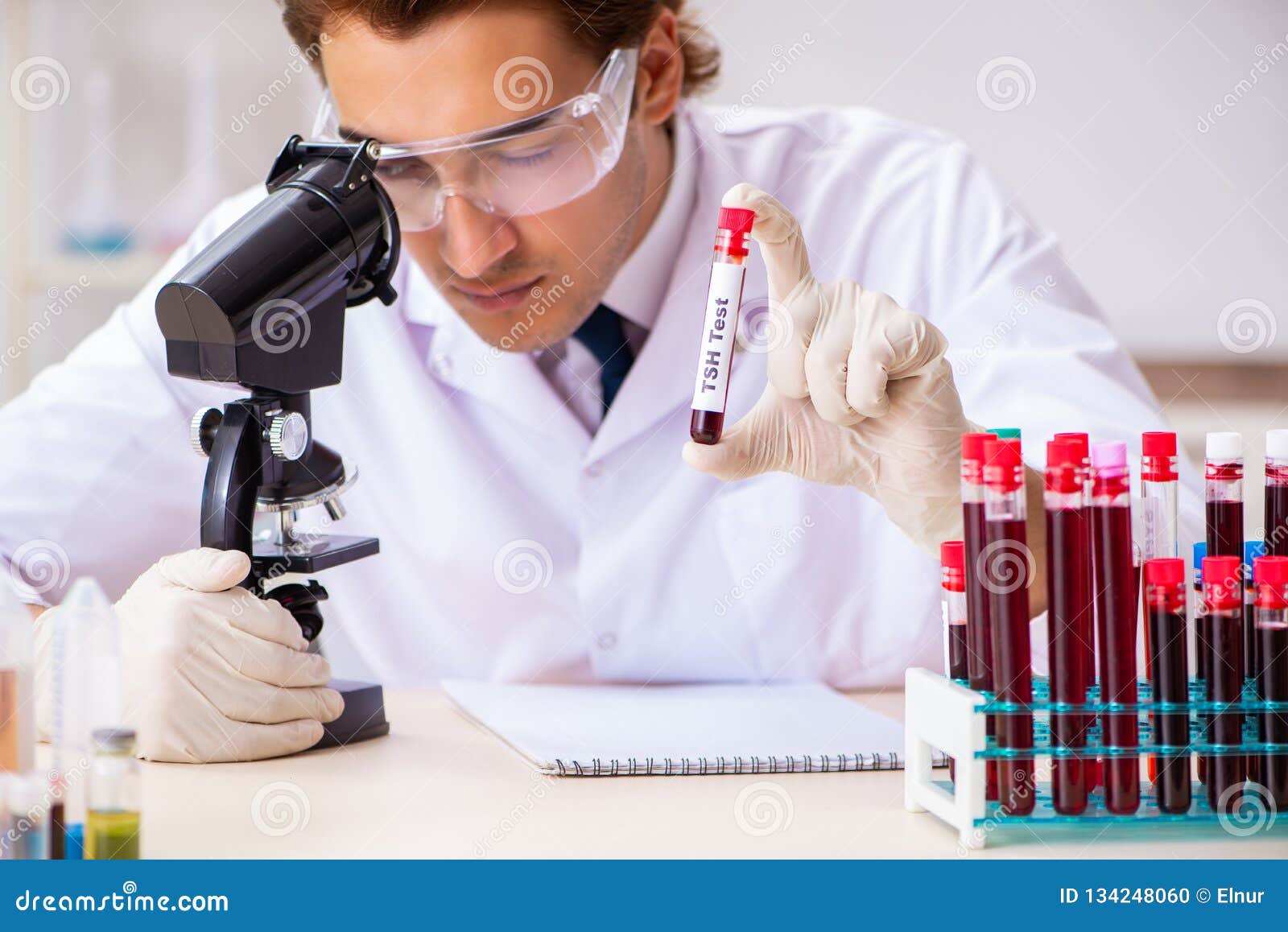 The Young Handsome Lab Assistant Testing Blood Samples in Hospital ...