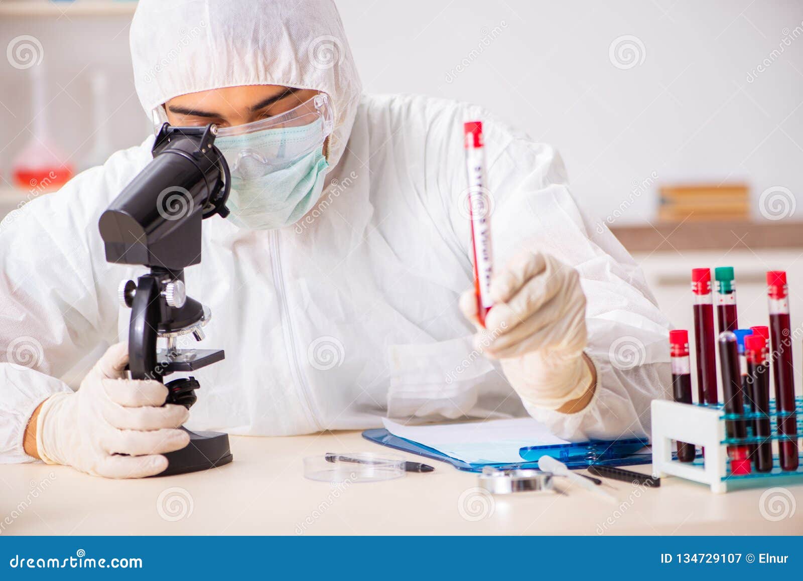 The Young Handsome Lab Assistant Testing Blood Samples in Hospital ...