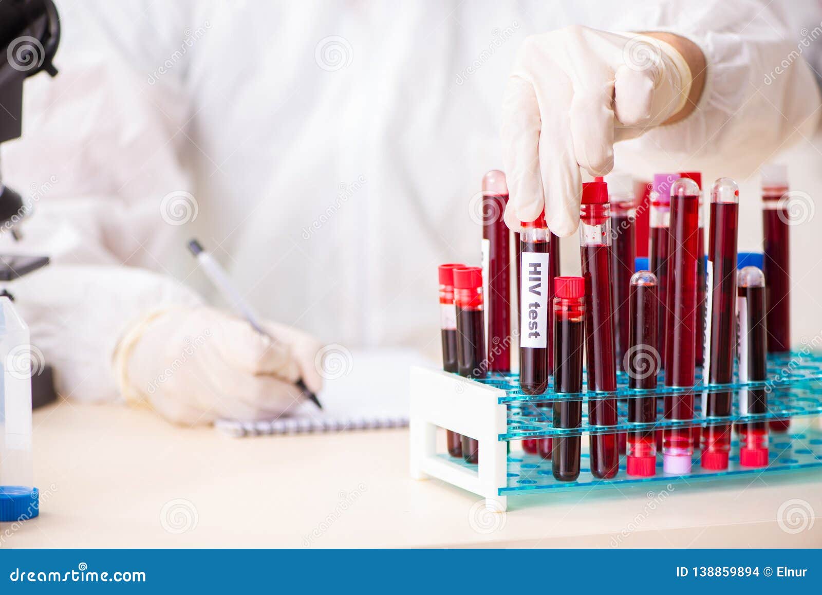The Young Handsome Lab Assistant Testing Blood Samples in Hospital ...