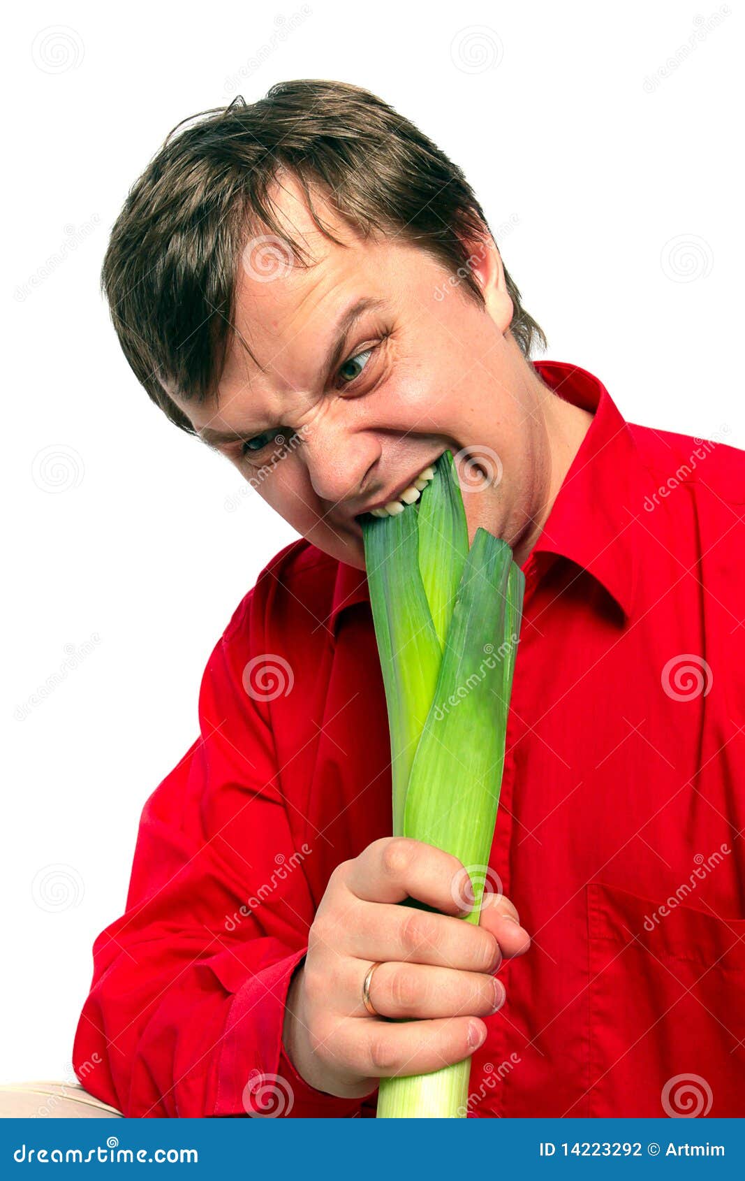 Young Handsome Man is Biting a Green Leek. Stock Photo - Image of ...