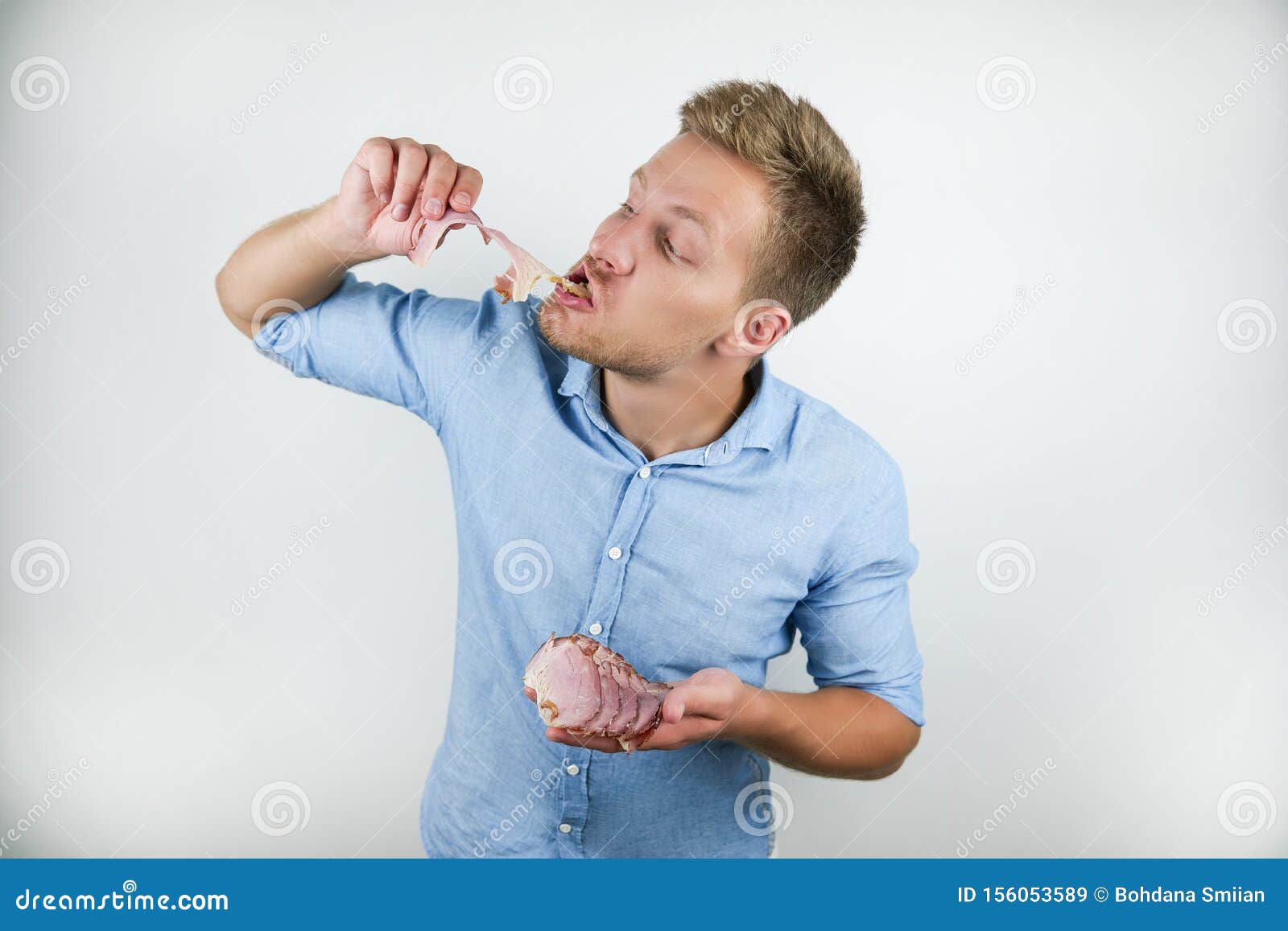 Young Handsome Man Biting Slice of Bacon with Hunger on White ...