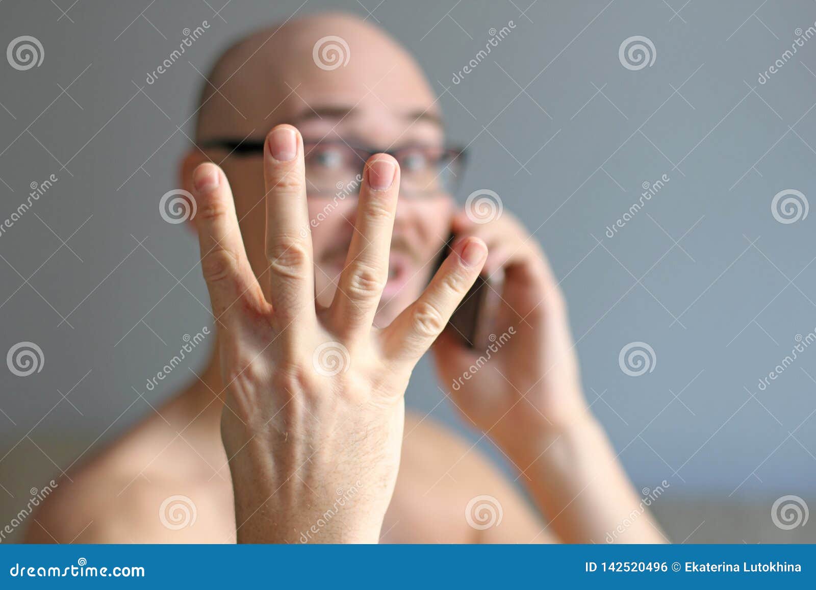 Young Handsome Man In Black Glasses Is Talking On The Phone Closeup