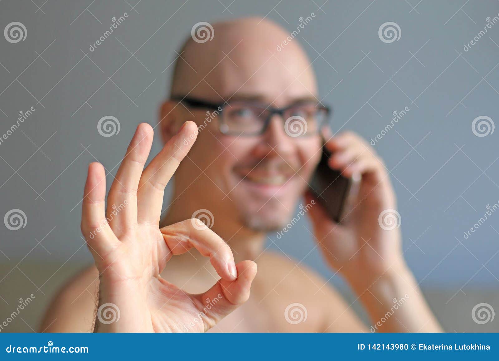 Young Handsome Man In Black Glasses Is Talking On The Phone Positive