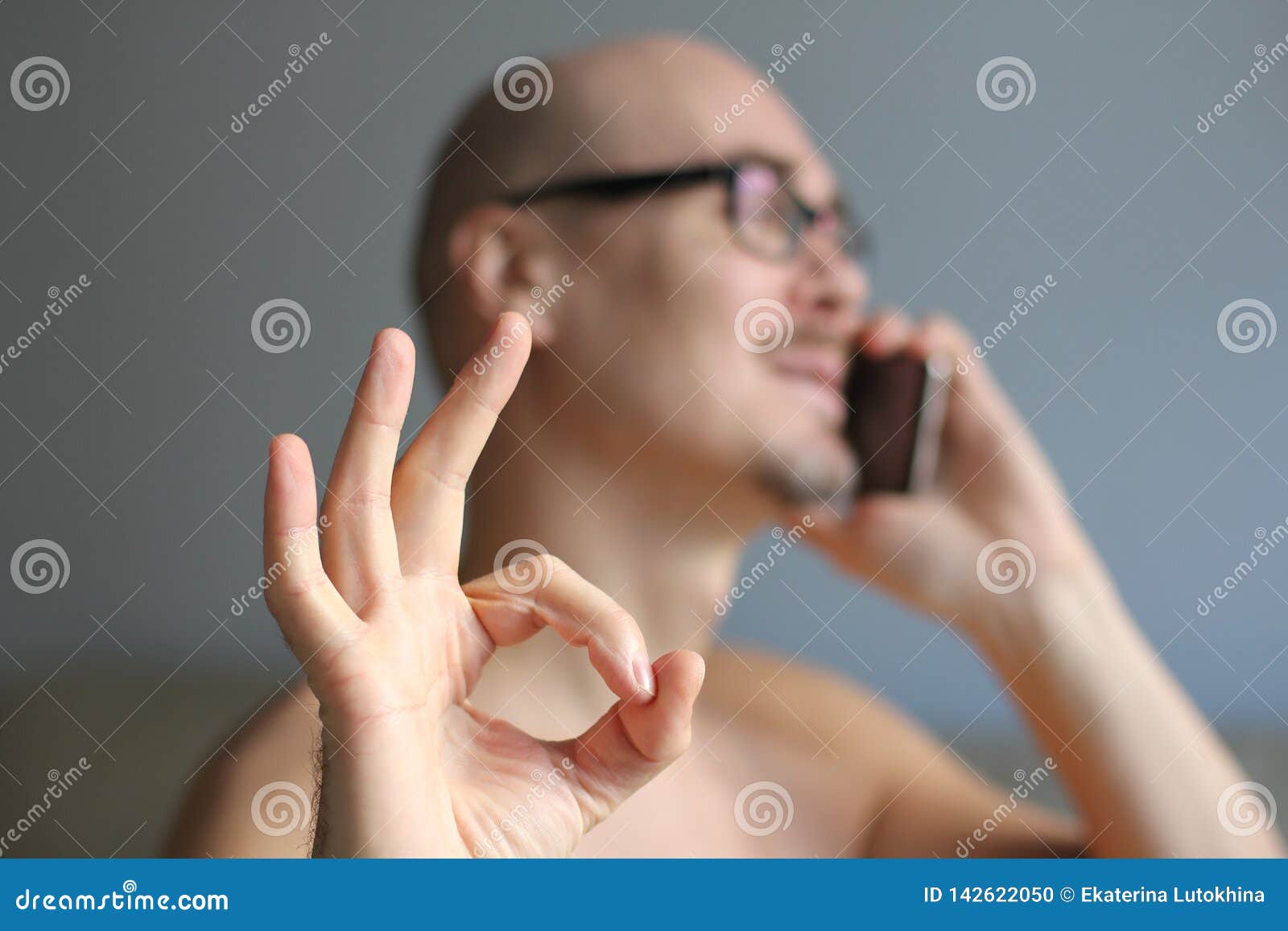 Young Handsome Man In Black Glasses Is Talking On The Phone Positive