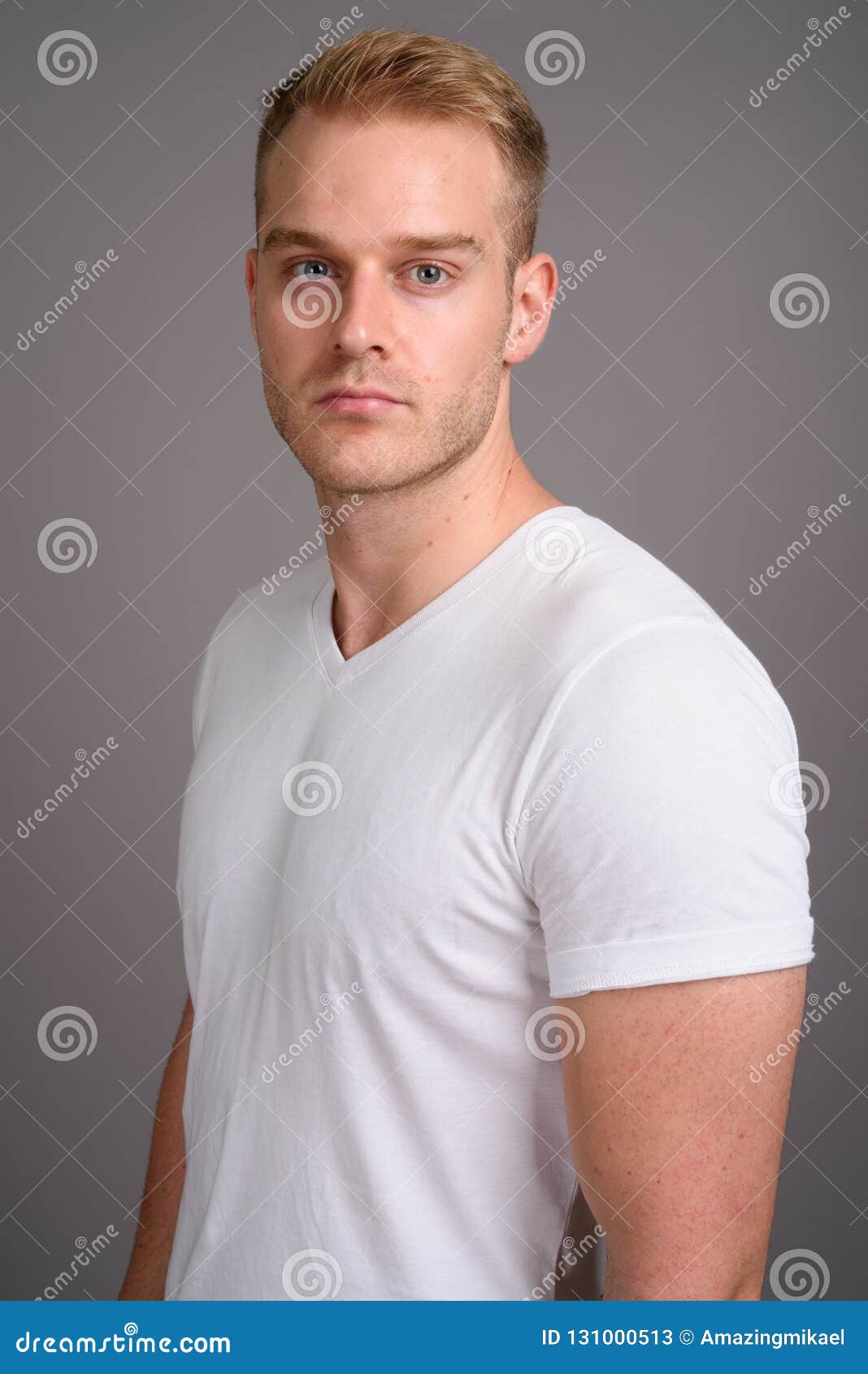 Young Handsome Man With Blond Hair Against Gray Background Stock Image