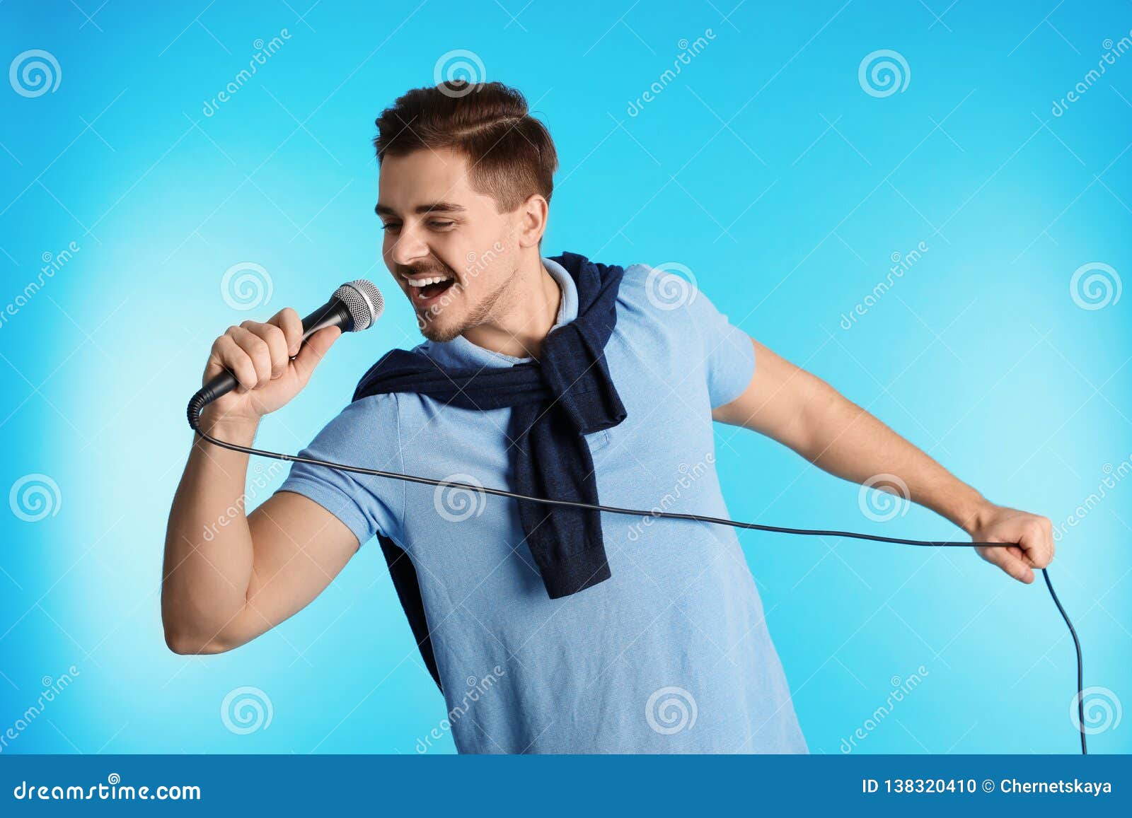 Young Handsome Man in Casual Clothes Singing with Microphone Stock ...