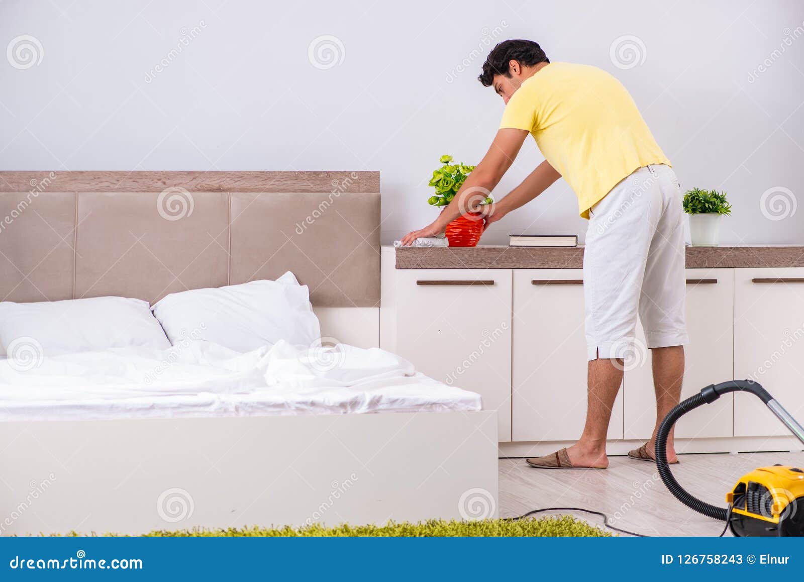 The Young Handsome Man Cleaning in the Bedroom Stock Image - Image of ...