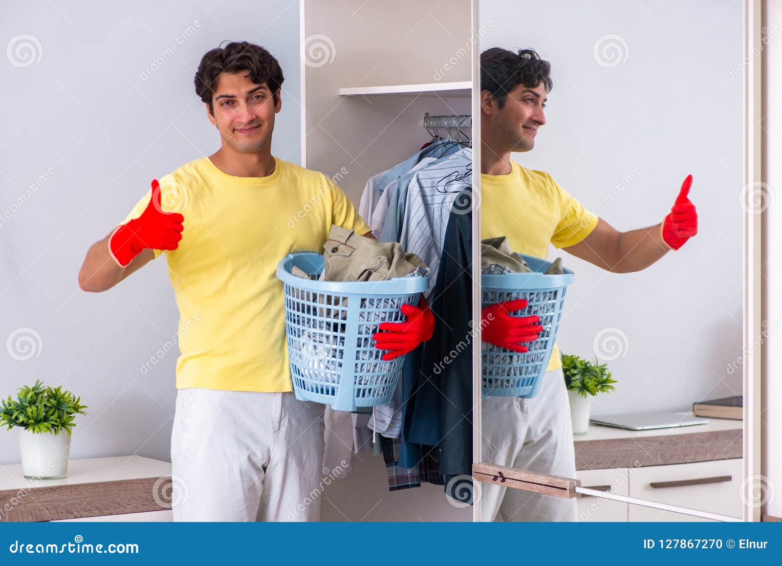 The Young Handsome Man Cleaning in the Bedroom Stock Photo - Image of ...