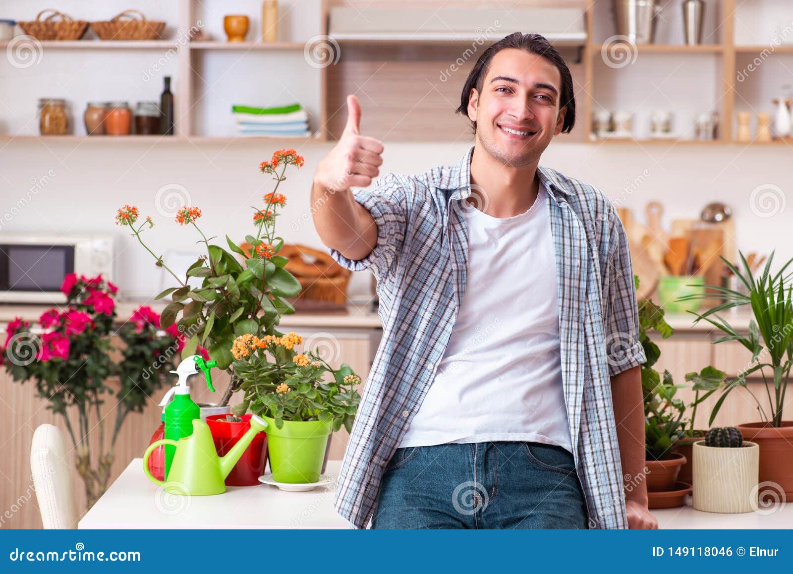 The Young Handsome Man Cultivating Flowers at Home Stock Photo - Image ...