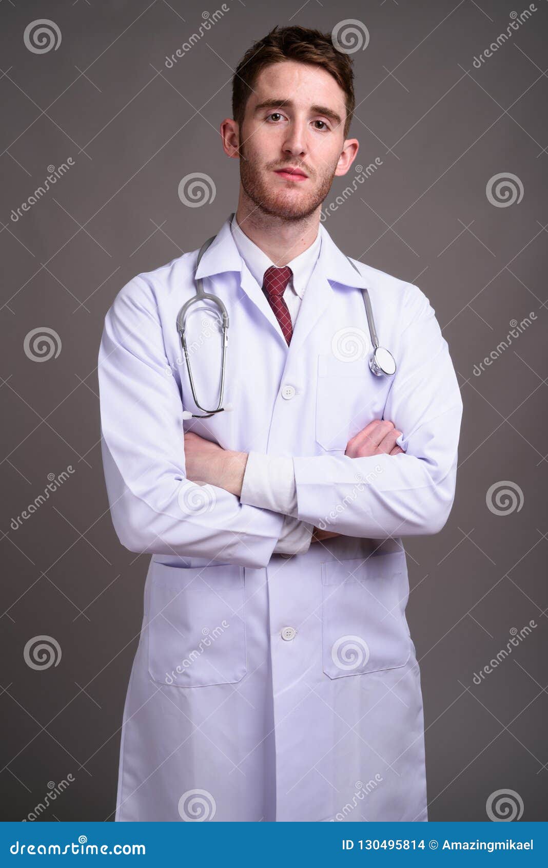 Young Handsome Man Doctor Against Gray Background Stock Photo - Image ... Young Handsome Man Doctor Against Gray Background Stock Photo - Image ...
