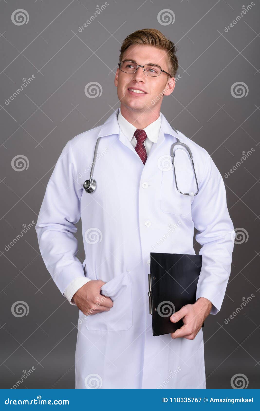 Young Handsome Man Doctor With Blond Hair Against Gray Backgroun Stock ... Young Handsome Man Doctor With Blond Hair Against Gray Backgroun Stock ...
