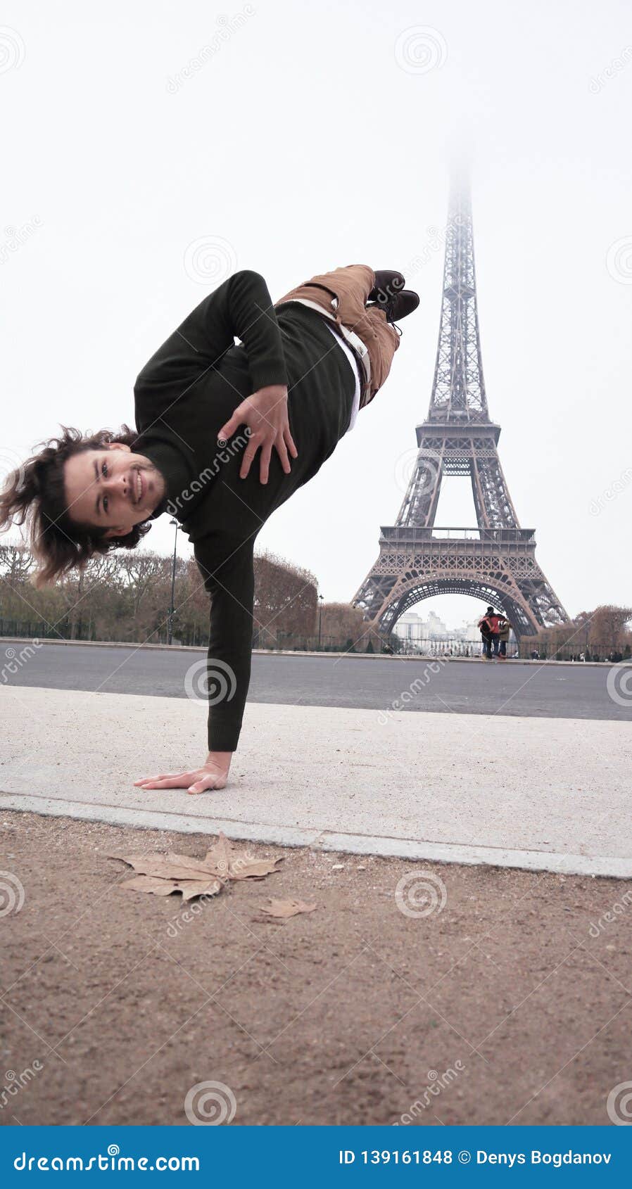 A Young Handsome Man Doing a Handstand in Paris in Front of Tower ...