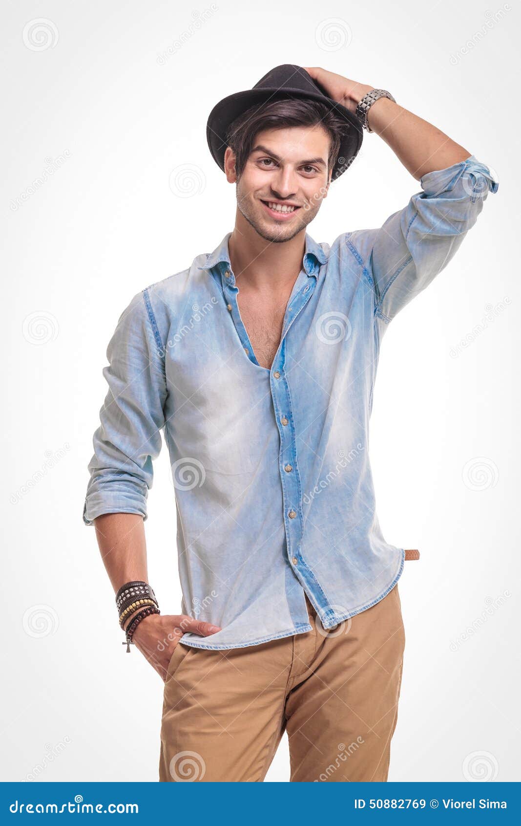 Young Handsome Man Fixing His Hat. Stock Image - Image of bracelet ...