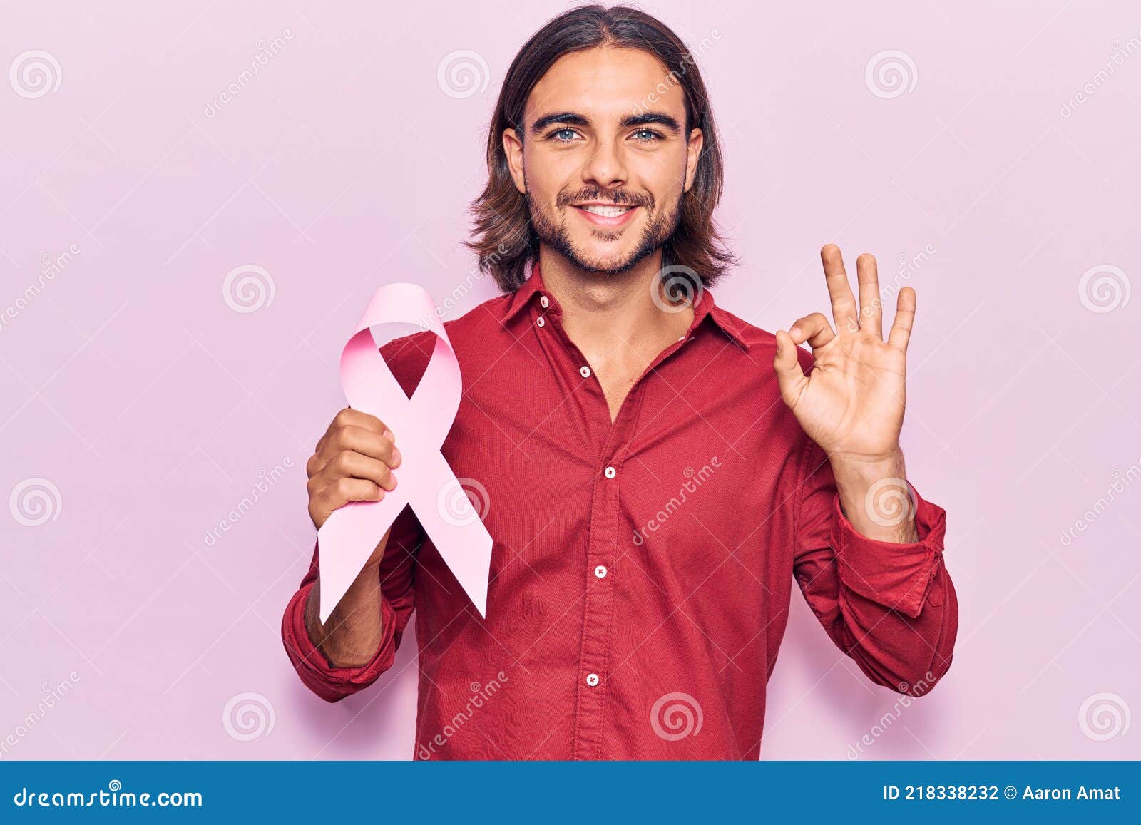 Young Handsome Man Holding Pink Cancer Ribbon Doing Ok Sign With