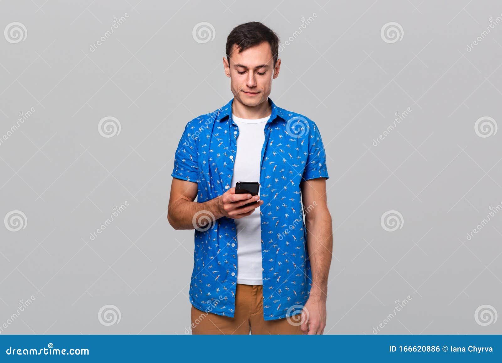 Young Handsome Man Holding Smartphone Checking Notifications from a ...
