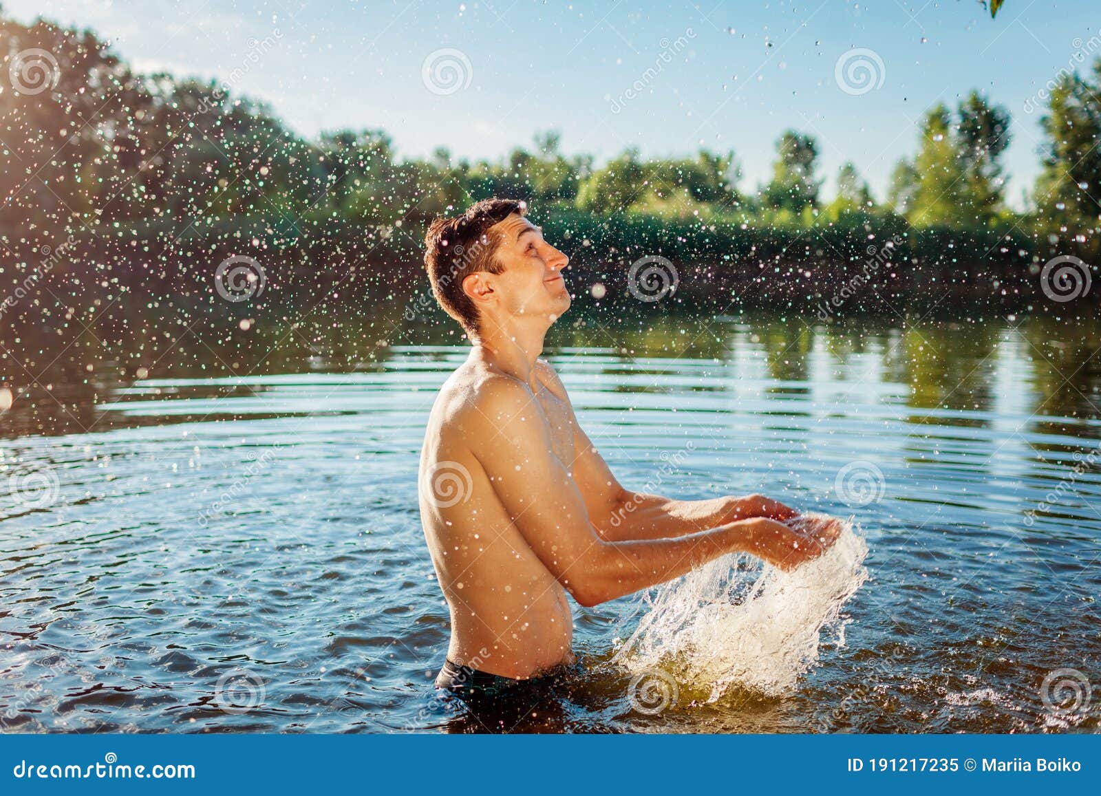 Young Handsome Man Making Splashes in River. Guy Having Fun in Water ...