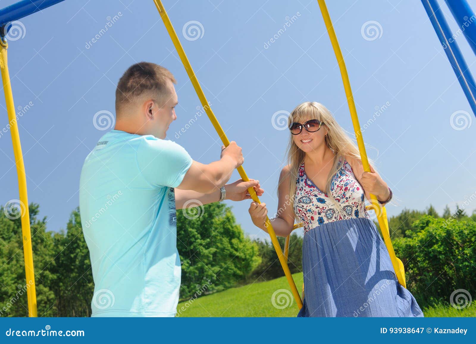 Young Handsome Man Pushing His Girlfriend on a Swing Stock Image ... Young Handsome Man Pushing His Girlfriend on a Swing Stock Image ...