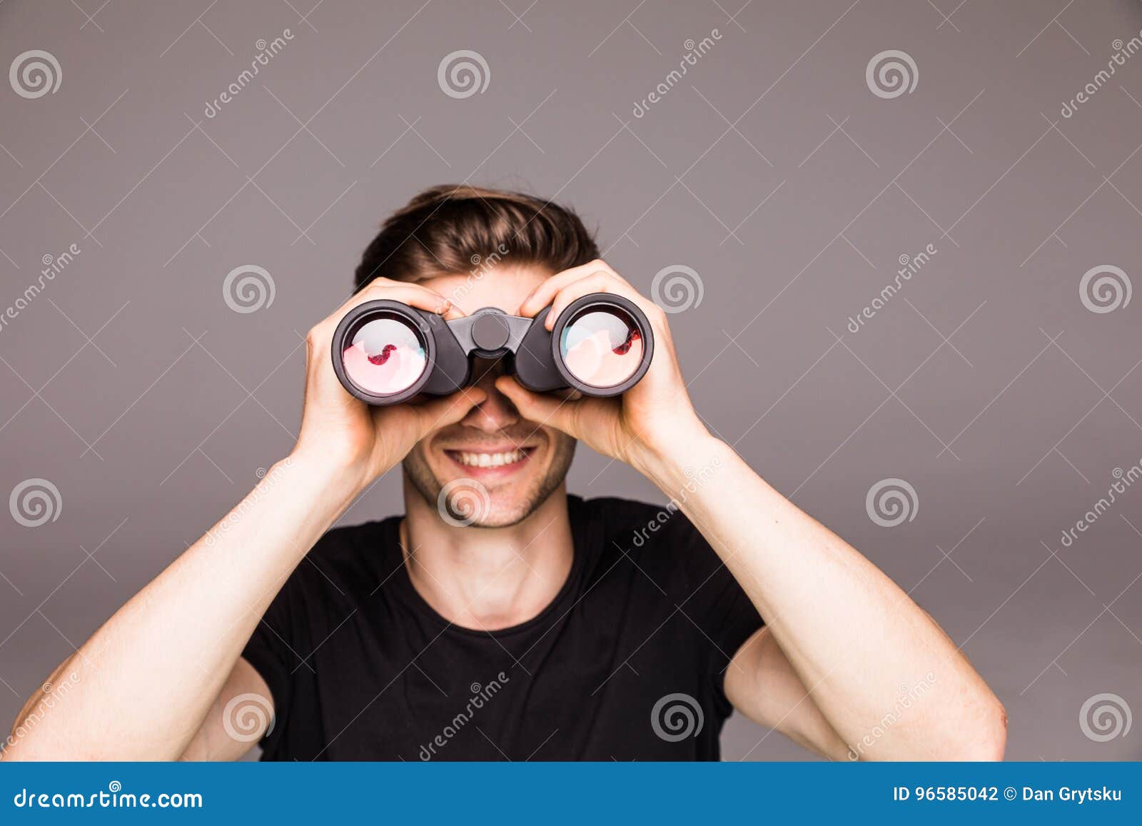 Young Handsome Man Searching with Binoculars Near Laptop at Office Work ...