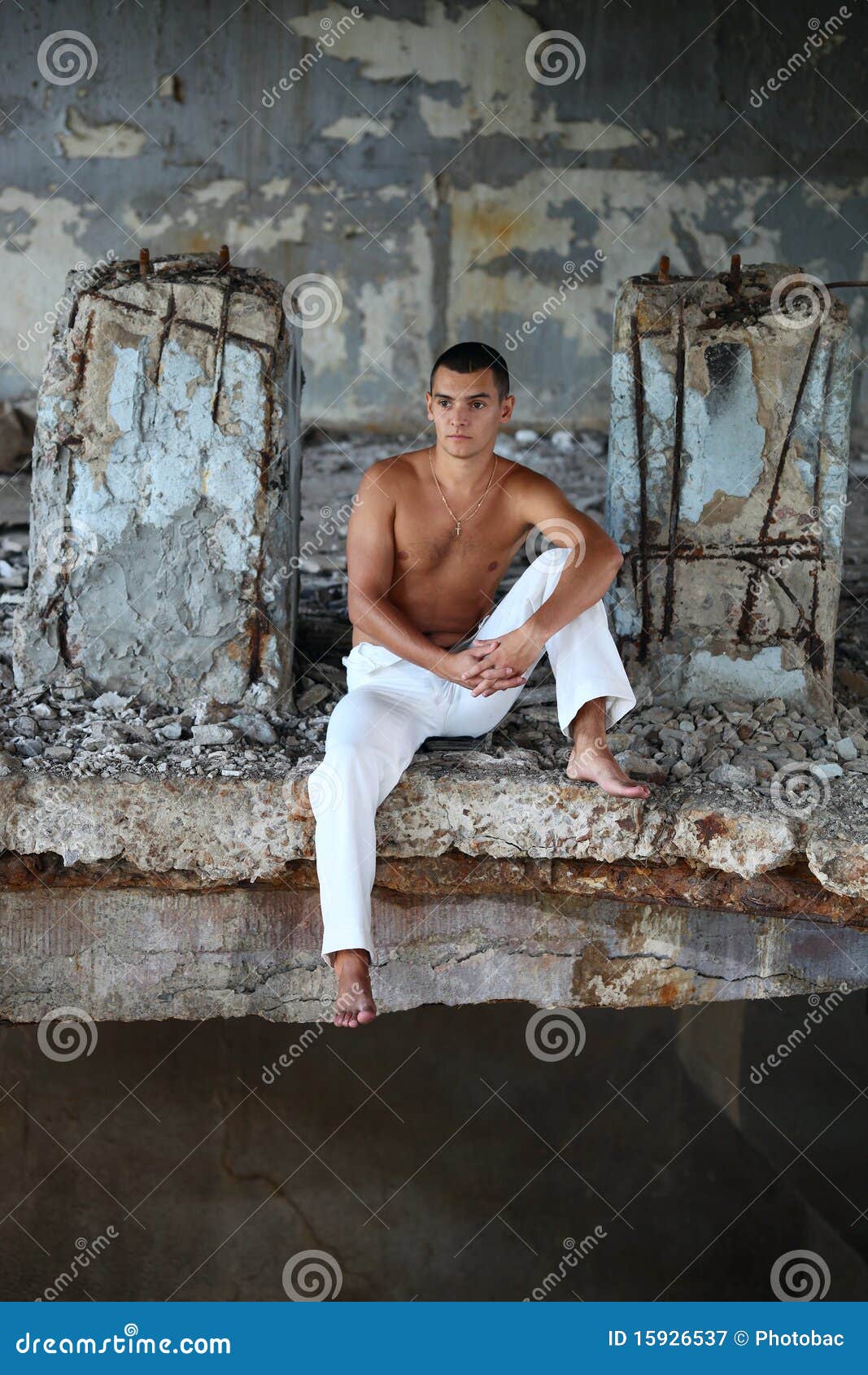 Young Handsome Man Sitting on Edge of Floor Stock Image - Image of male ...