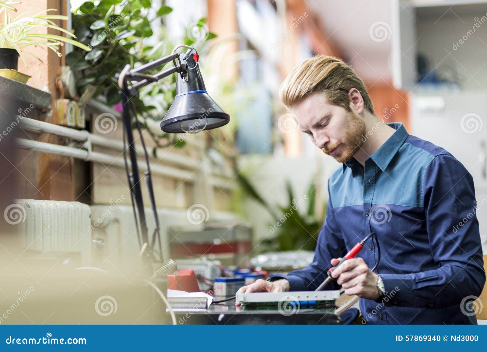 Young Handsome Man Soldering a Circuit Board Stock Photo - Image of ...