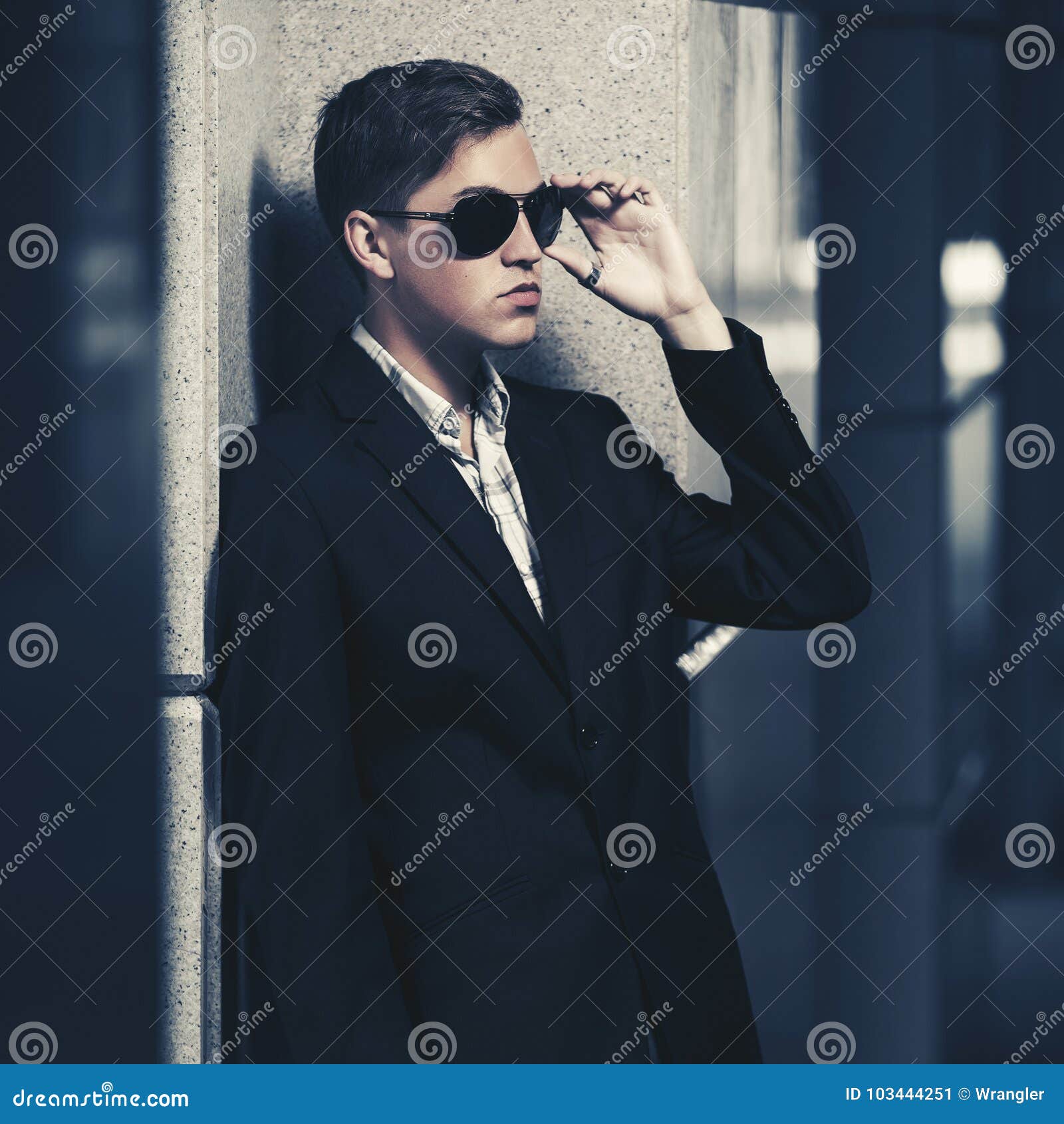 Young Handsome Man In Sunglasses Standing At The Wall Stock Image