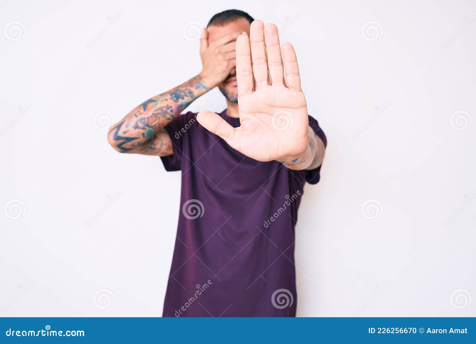 Young Handsome Man With Tattoo Wearing Casual Clothes Covering Eyes