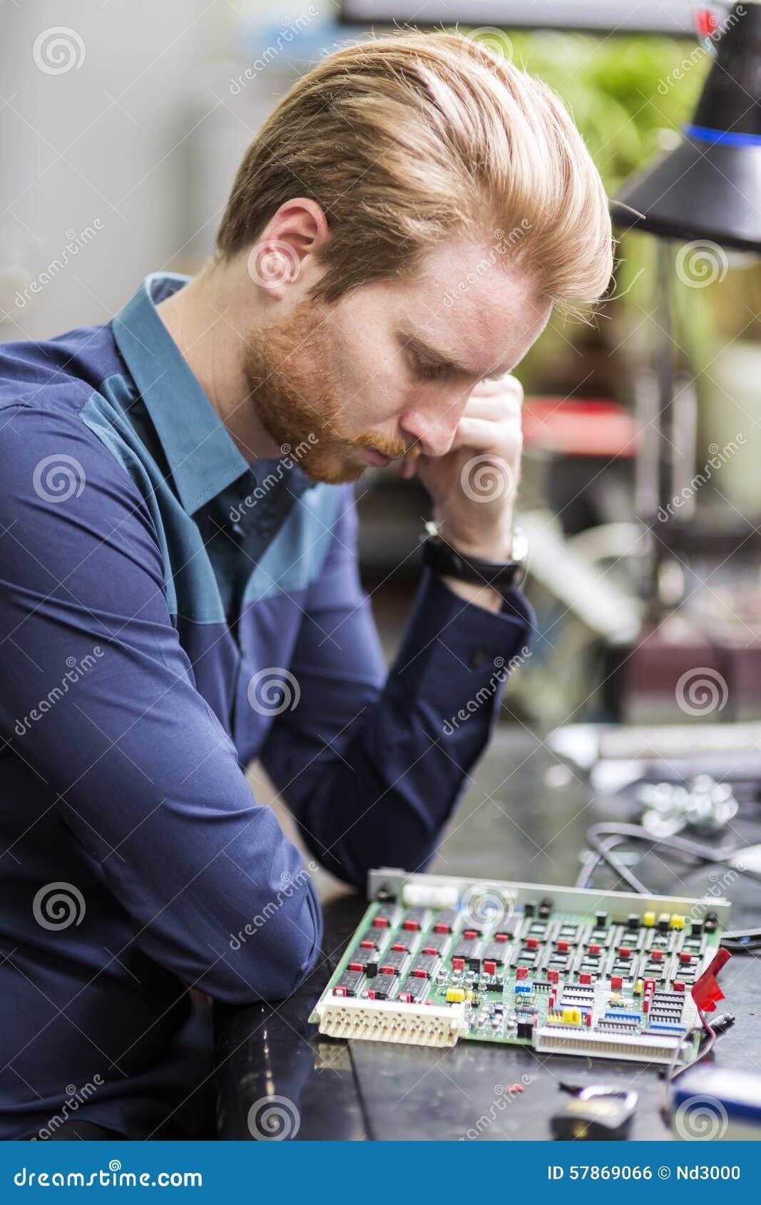 Young Handsome Man Thinking while Soldering a Circuit Board Stock Photo ...