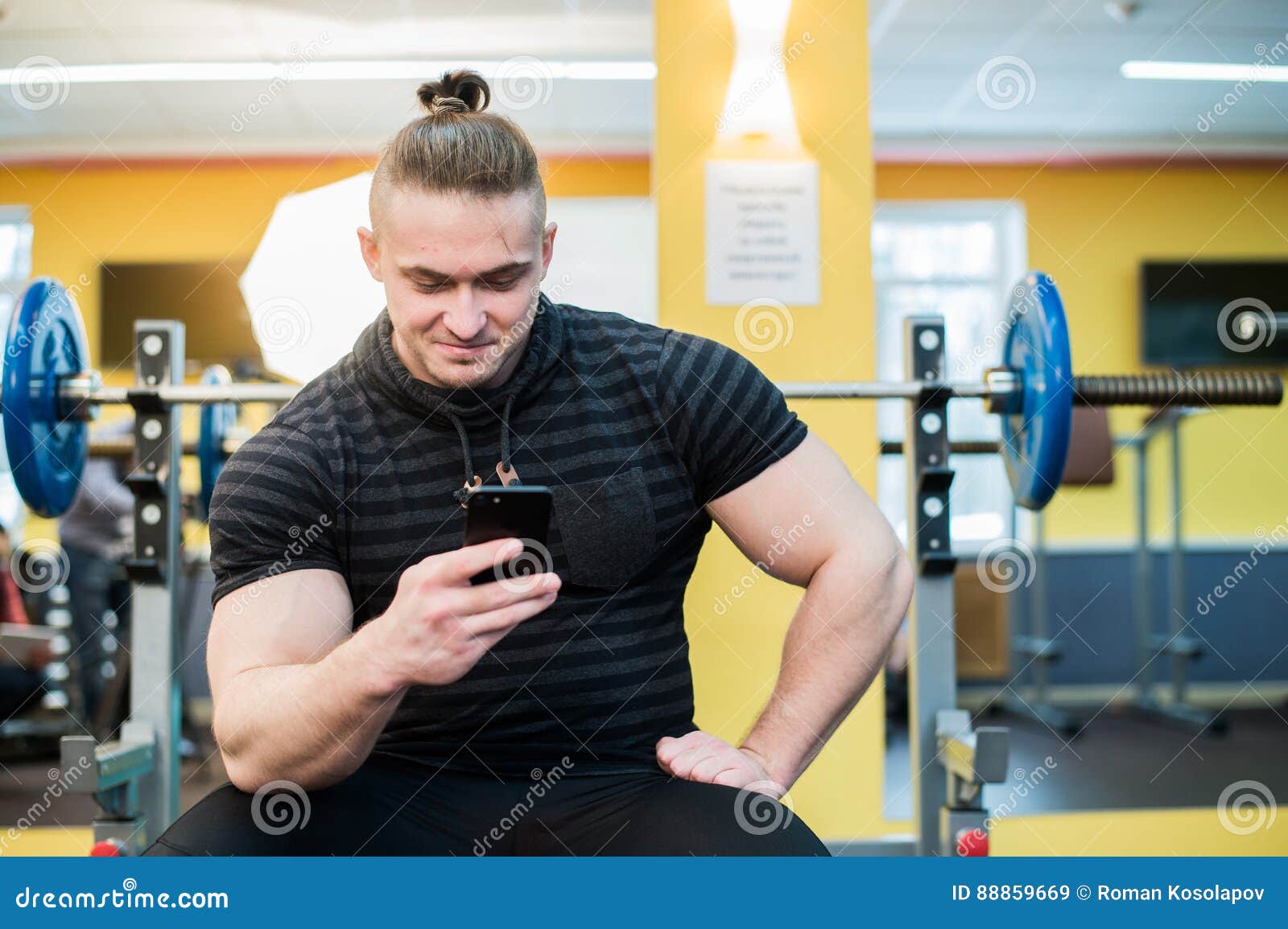 Young Handsome Man Using Phone while Having Exercise Break in Gym ...