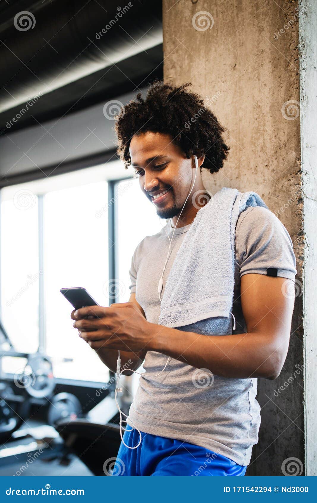 Young Handsome Man Using Phone while Having Exercise Break in Gym Stock ...