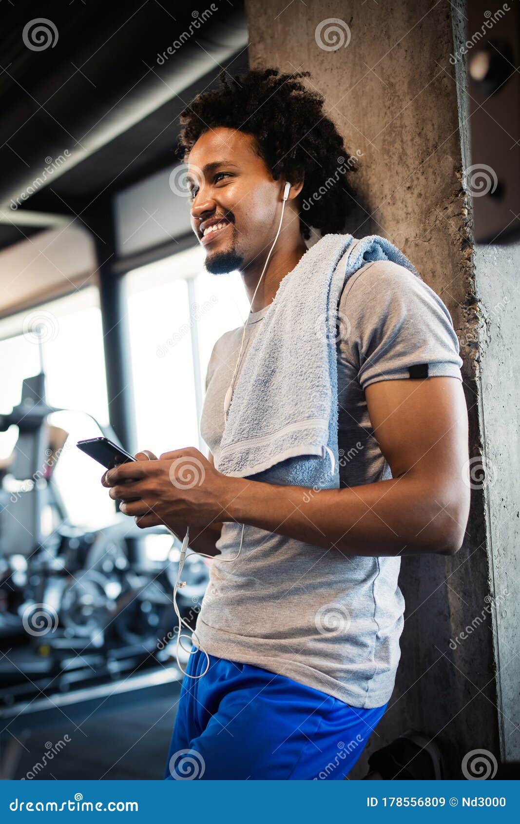 Young Handsome Man Using Phone while Having Exercise Break in Gym Stock ...