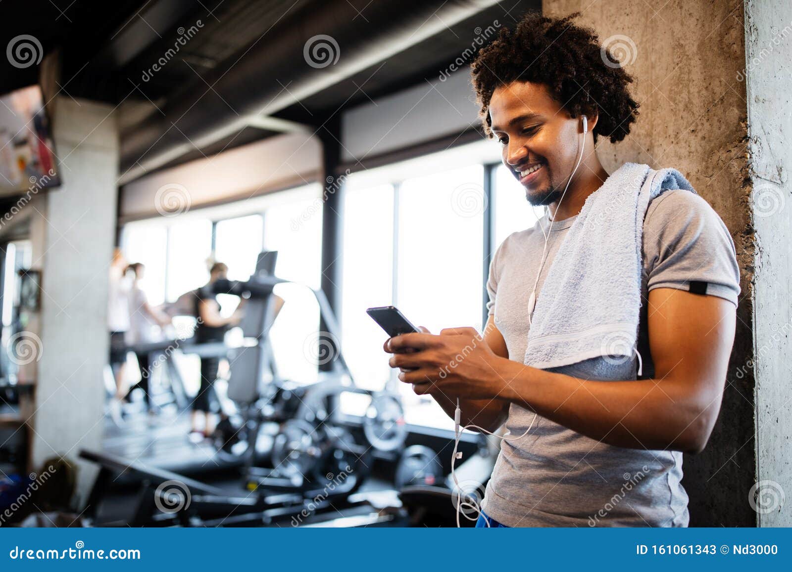Young Handsome Man Using Phone while Having Exercise Break in Gym Stock ...