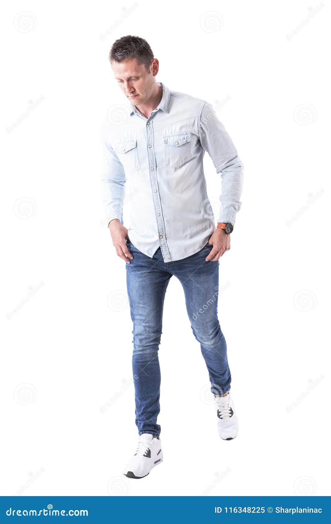 Young Handsome Man Walking with Hands in Pockets and Looking Down ...