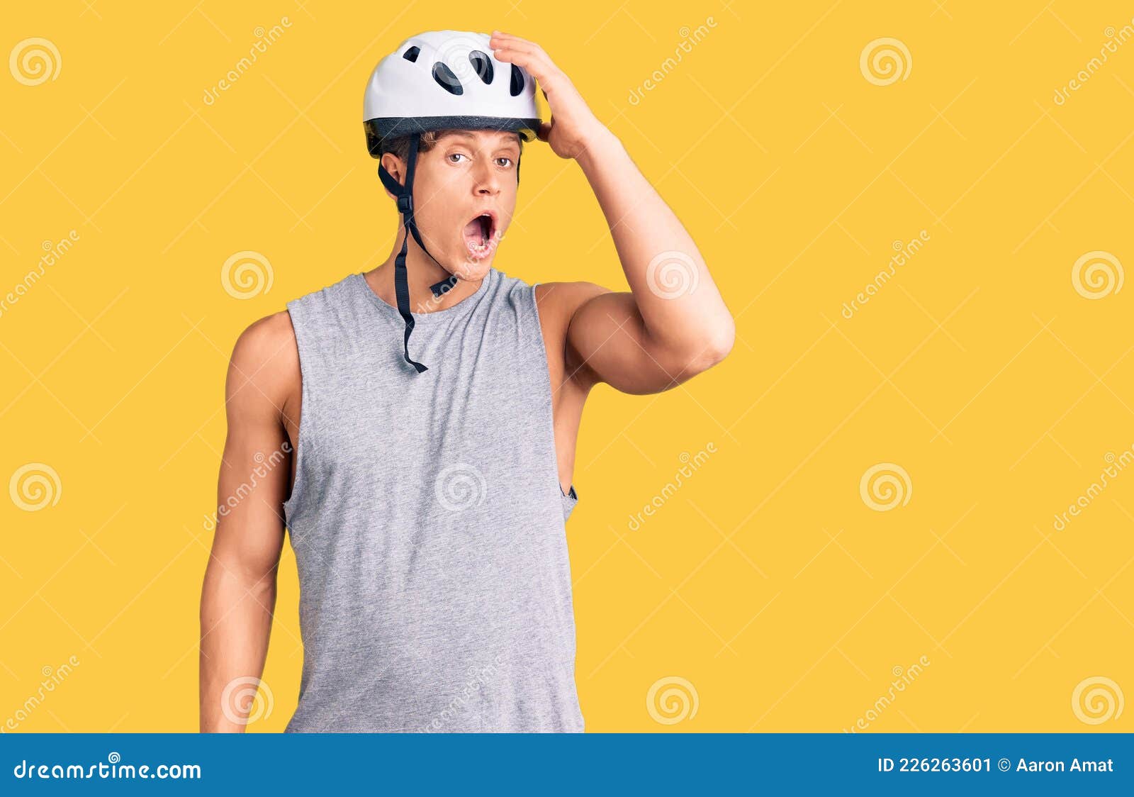 Young Handsome Man Wearing Bike Helmet Surprised With Hand On Head For