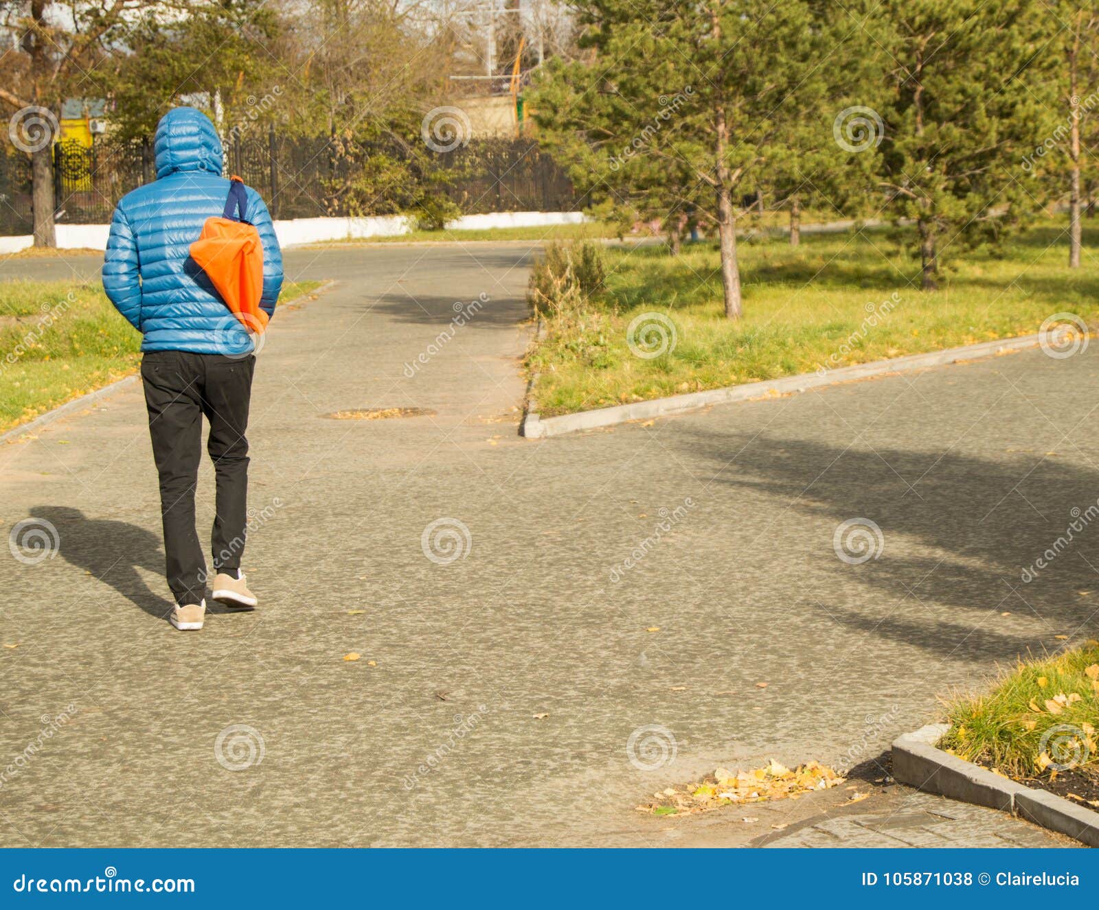Young Handsome Man Wearing a Blue Jacket with a Sports Bag, Walking in ... Young Handsome Man Wearing a Blue Jacket with a Sports Bag, Walking in ...