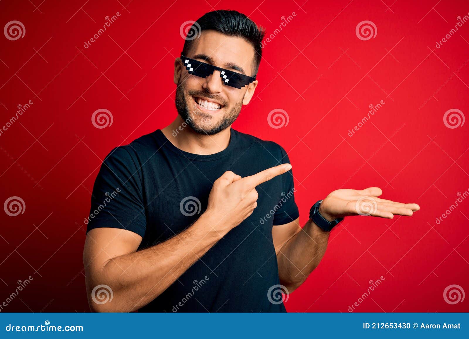 Young Handsome Man Wearing Funny Thug Life Sunglasses Over Isolated Red