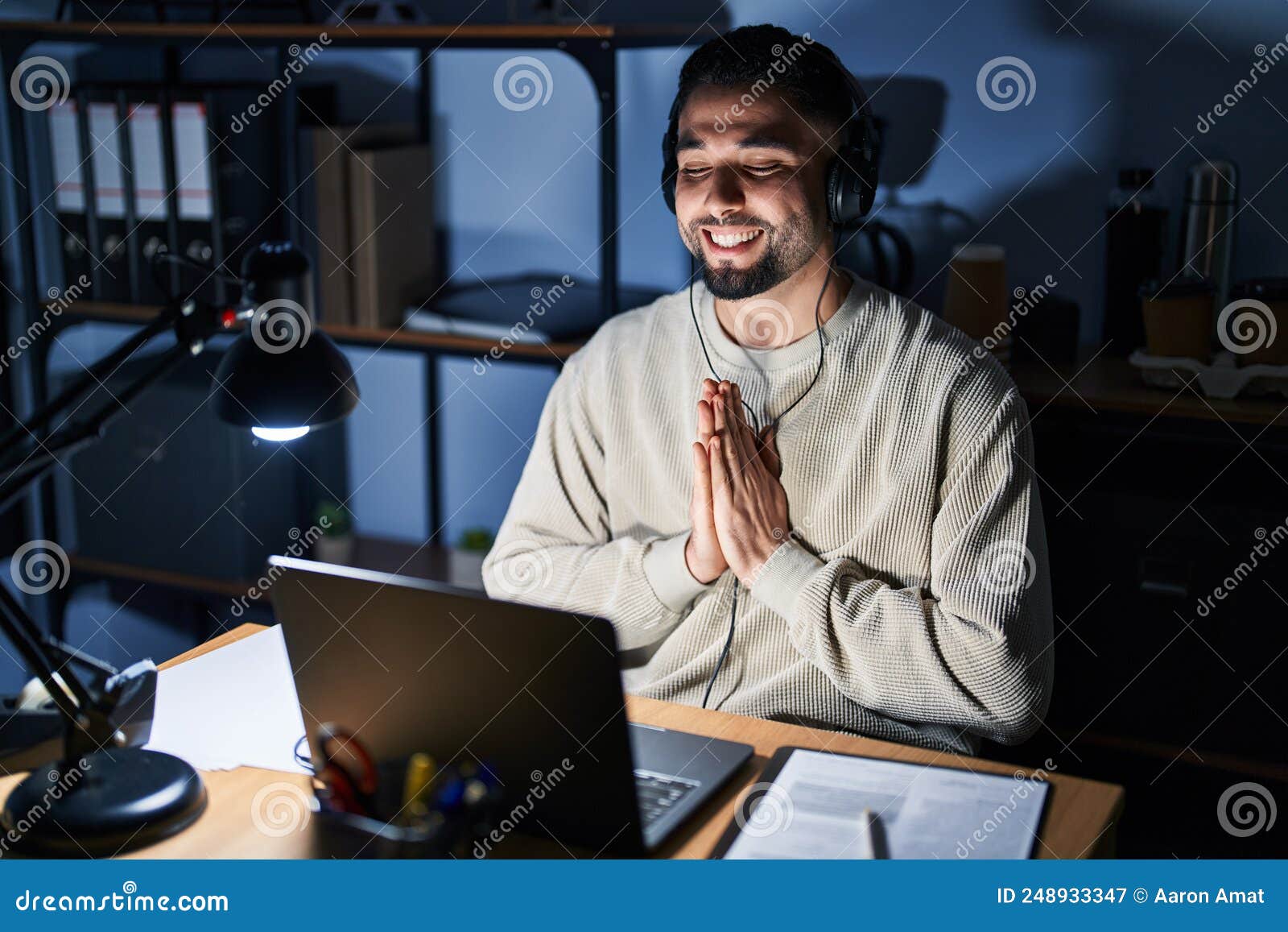 Young Handsome Man Working Using Computer Laptop at Night Praying with ...