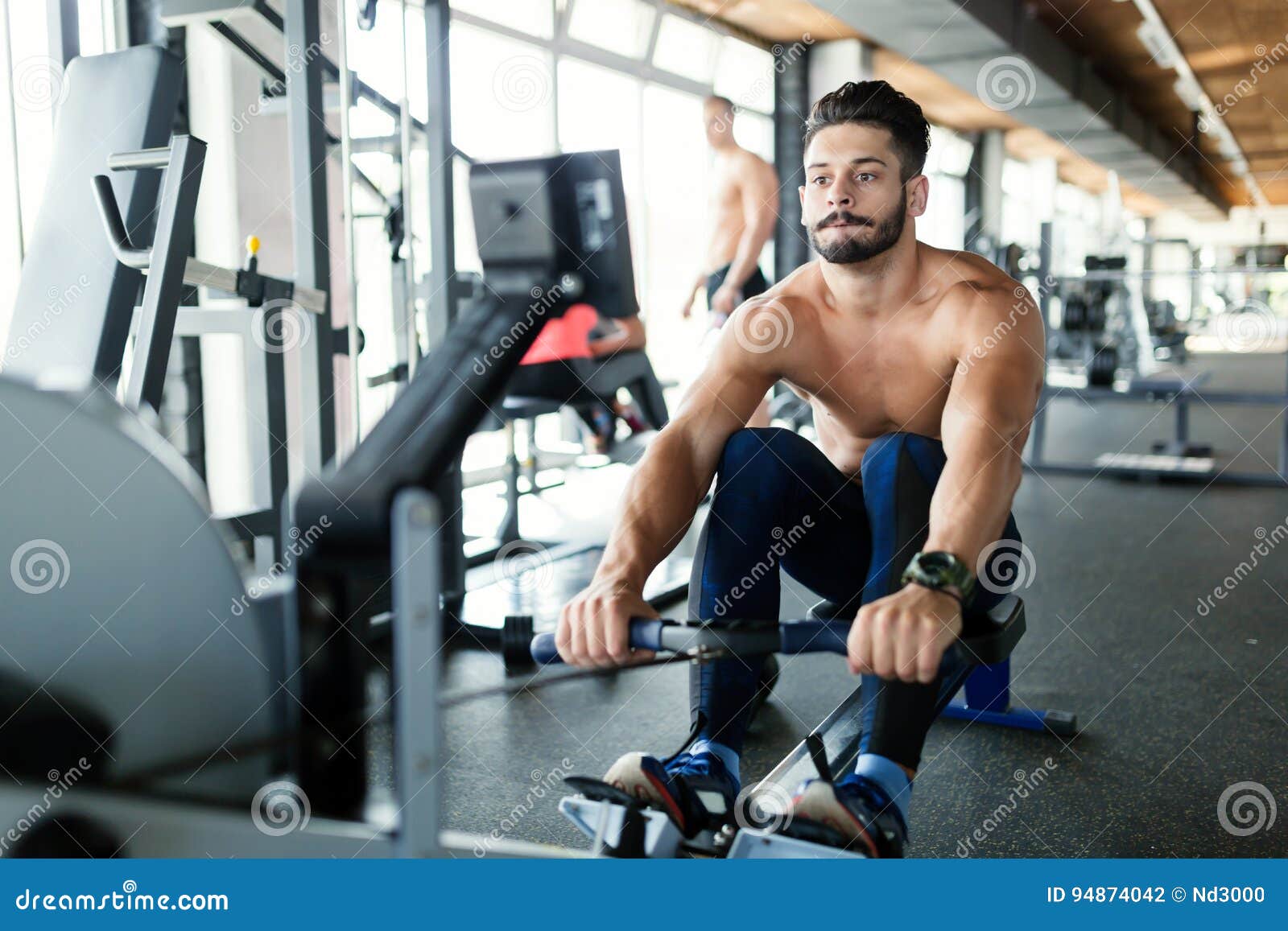 Young Handsome Man Workout with Rowing Machine Stock Photo - Image of ...