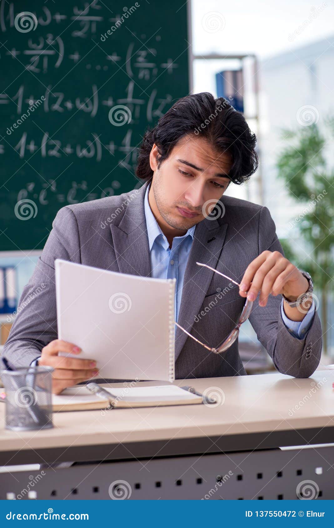 The Young Handsome Math Teacher in Classroom Stock Photo - Image of ...