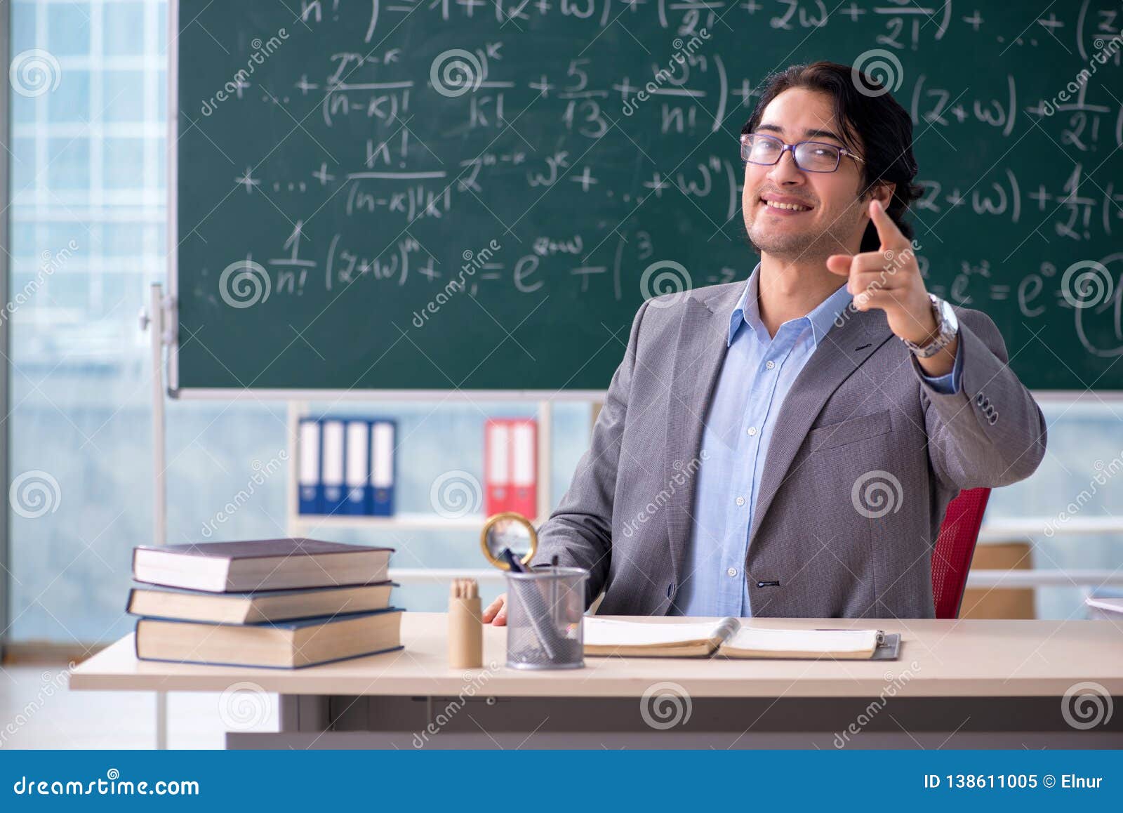 The Young Handsome Math Teacher in Classroom Stock Image - Image of ...