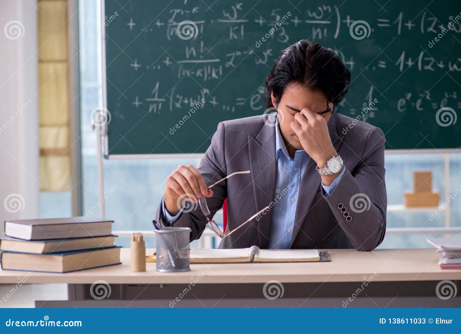The Young Handsome Math Teacher in Classroom Stock Image - Image of ...