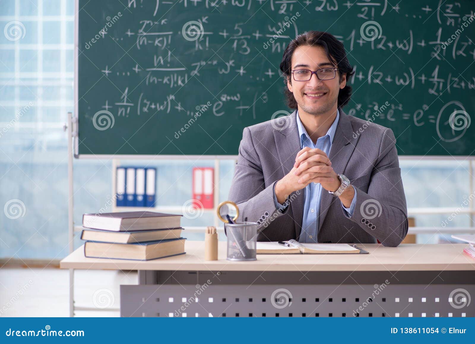 The Young Handsome Math Teacher in Classroom Stock Photo - Image of ...