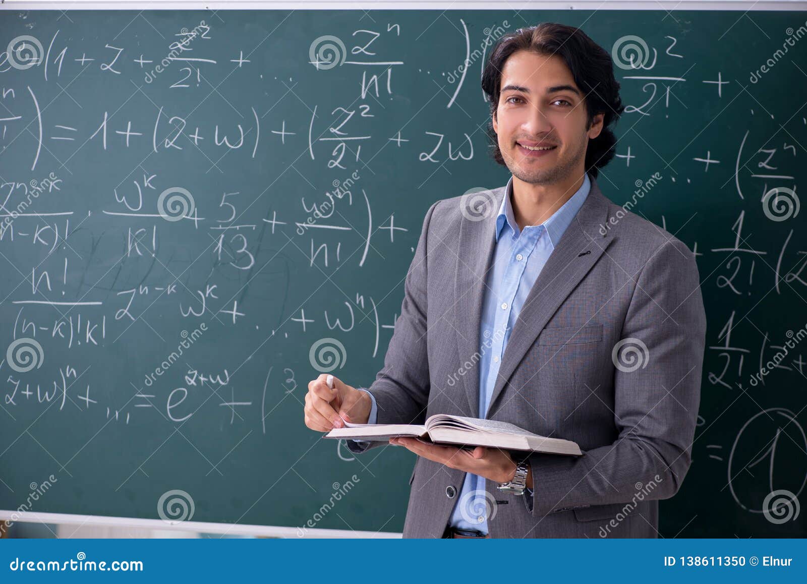 The Young Handsome Math Teacher in Classroom Stock Photo - Image of ...