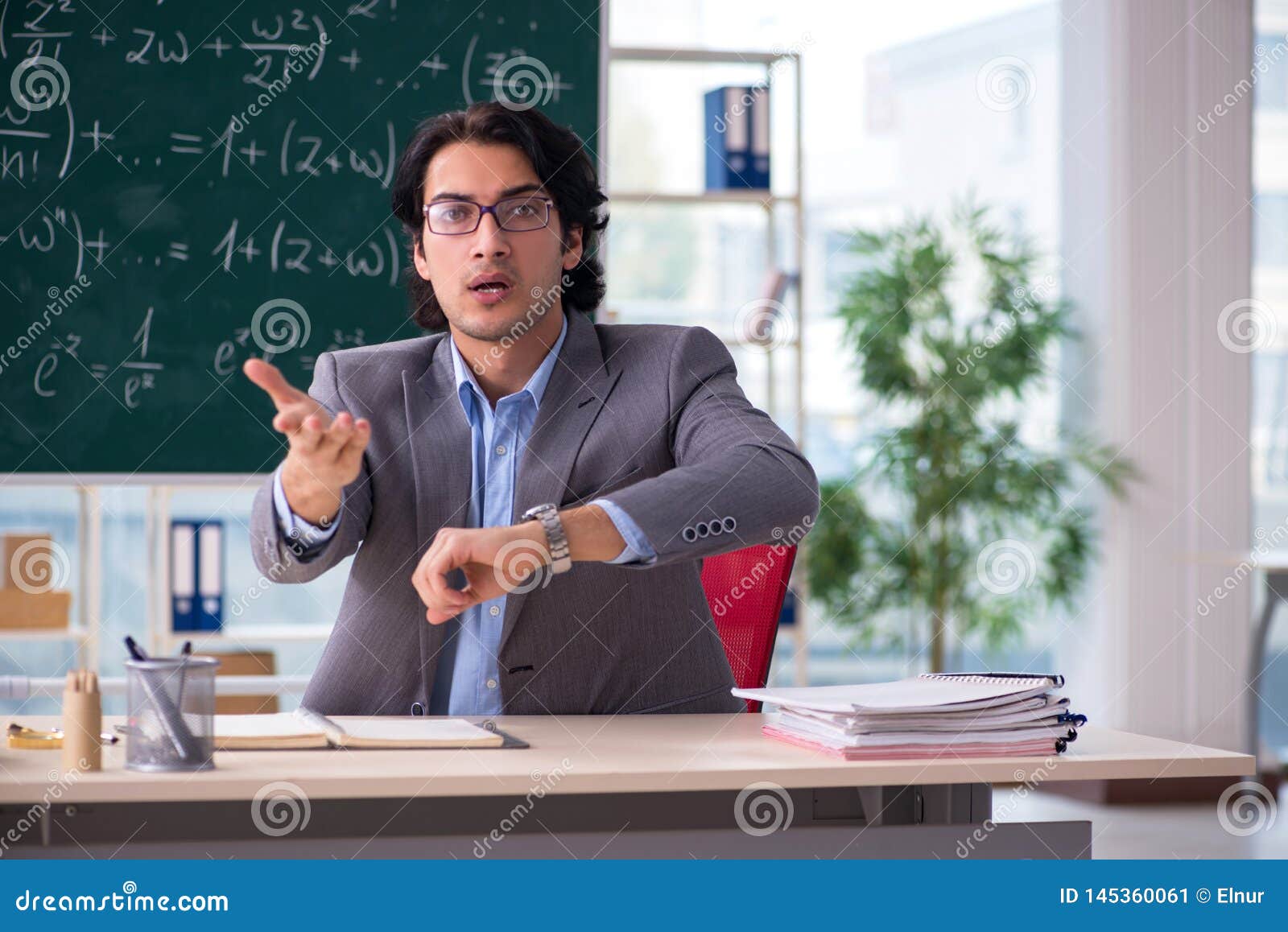 The Young Handsome Math Teacher in Classroom Stock Image - Image of ...