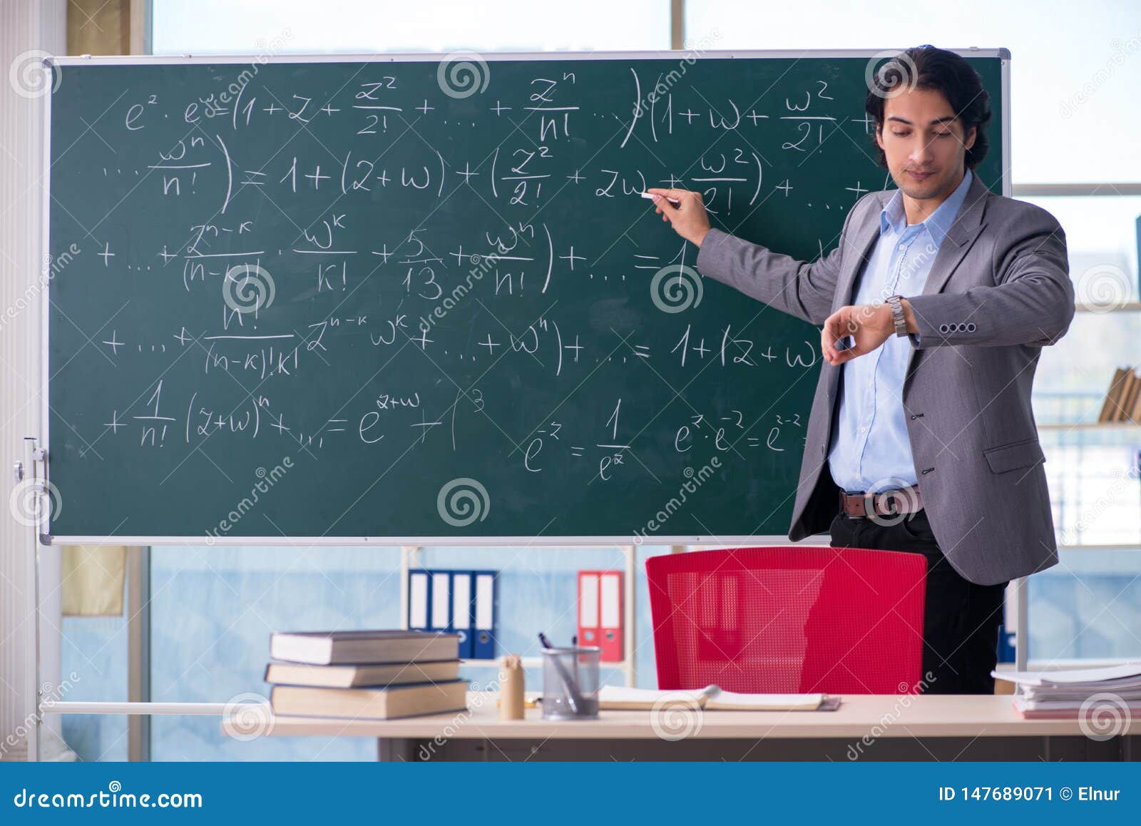 The Young Handsome Math Teacher in Classroom Stock Image - Image of ...