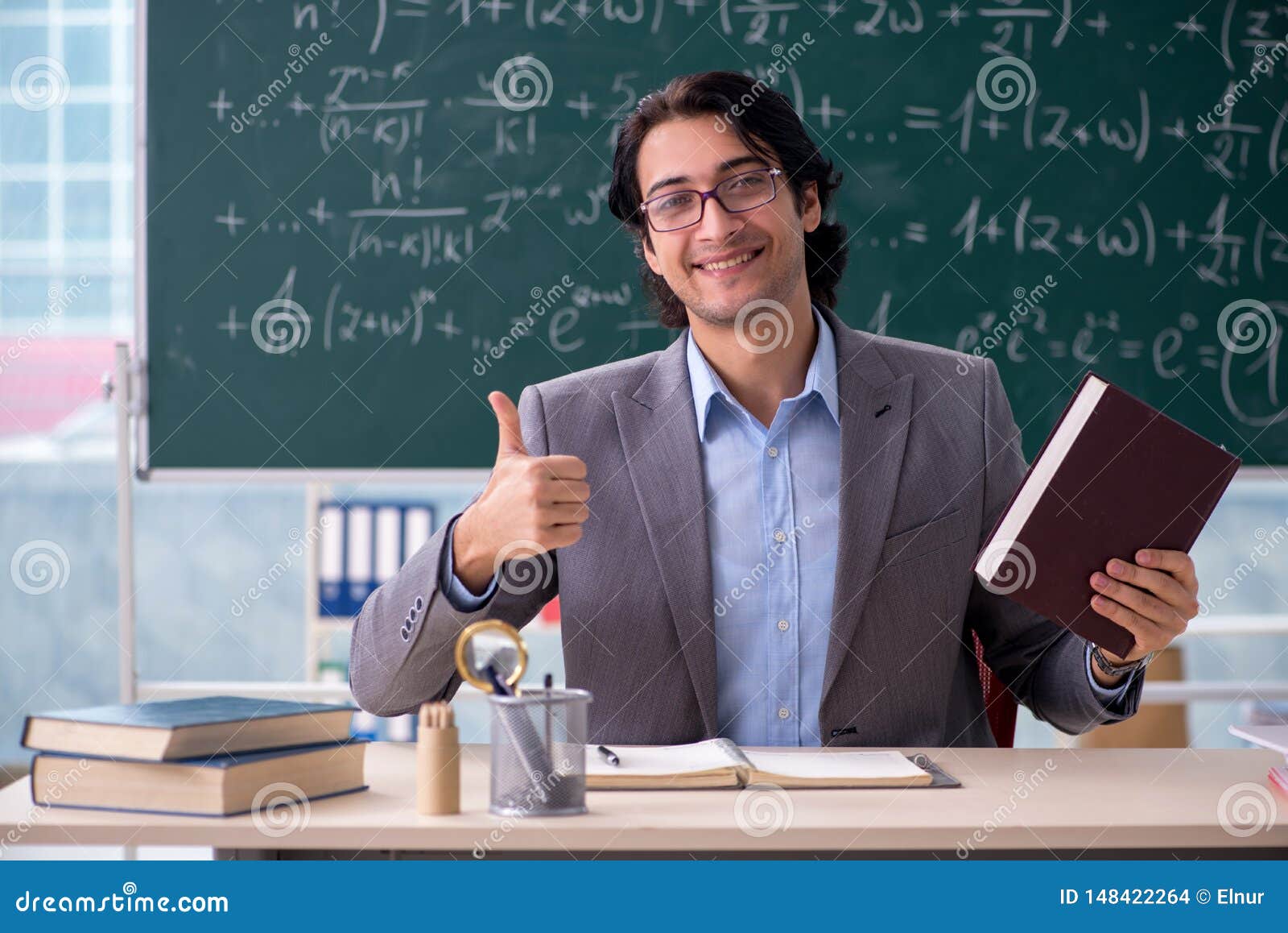 The Young Handsome Math Teacher in Classroom Stock Photo - Image of ...