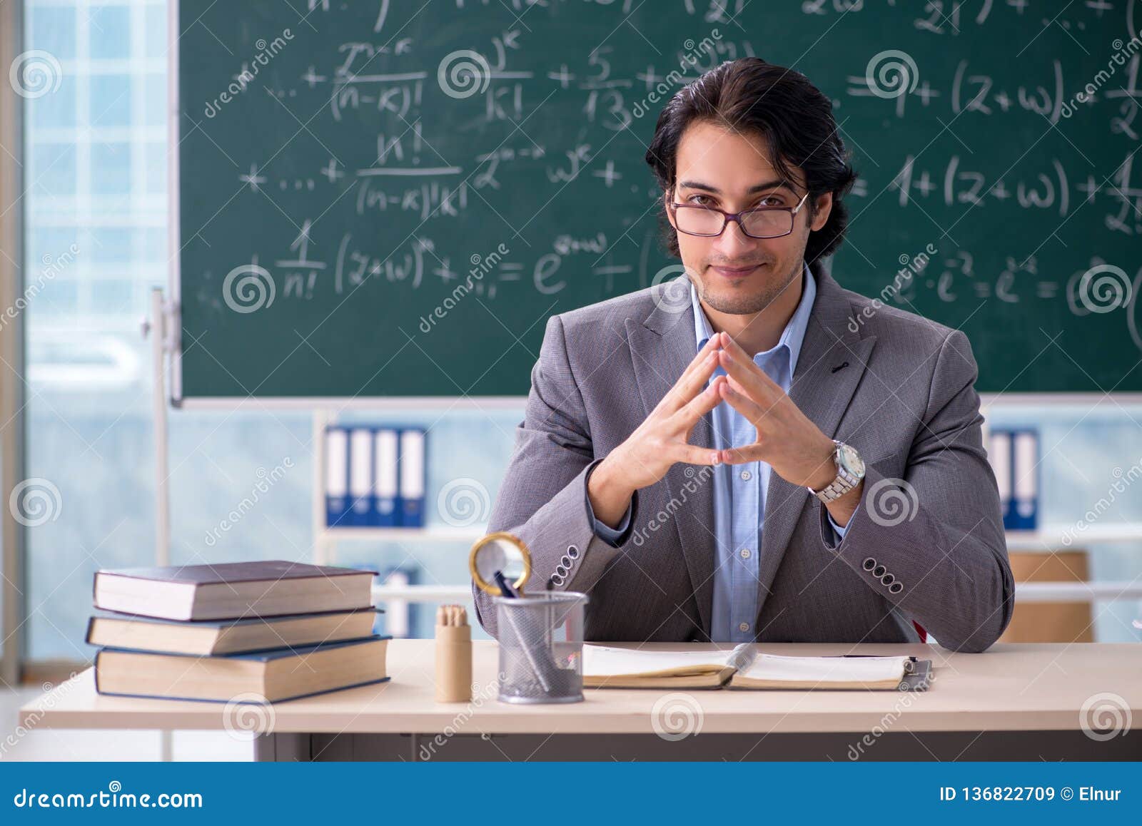 The Young Handsome Math Teacher in Classroom Stock Image - Image of ...