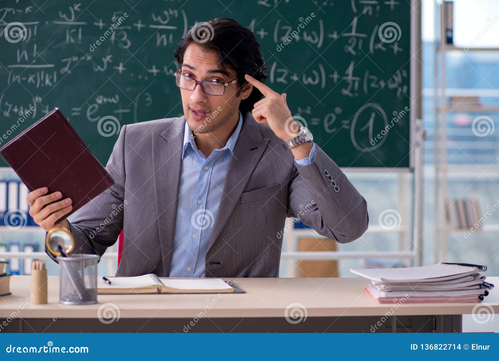 The Young Handsome Math Teacher in Classroom Stock Photo - Image of ...