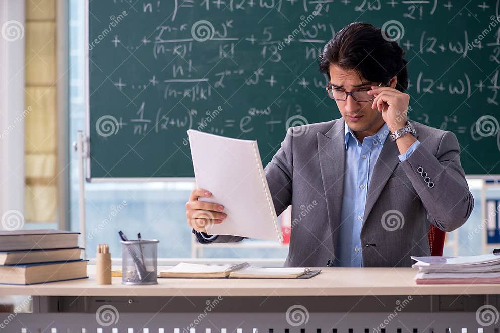 The Young Handsome Math Teacher in Classroom Stock Photo - Image of ...