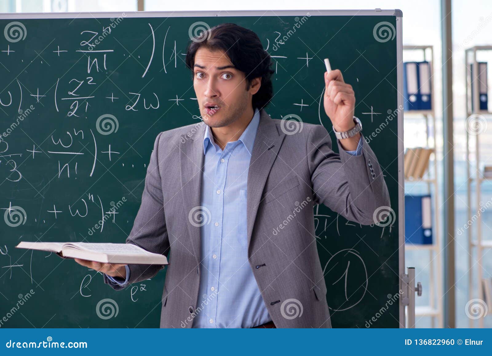 The Young Handsome Math Teacher in Classroom Stock Photo - Image of ...