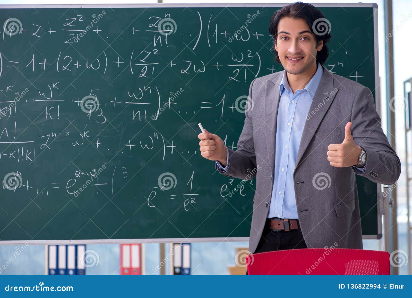 The Young Handsome Math Teacher in Classroom Stock Photo - Image of ...